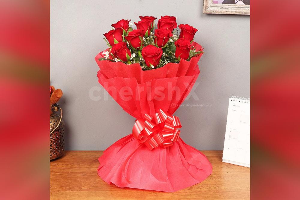 Send a simple 12 Red Roses in red color paper Bouquet to surprise them ...